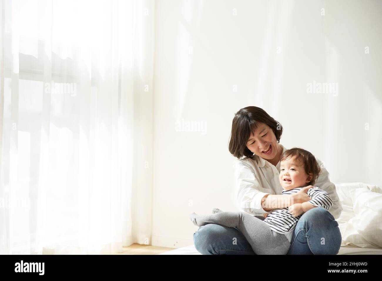 Boy being held by his mother Stock Photo - Alamy