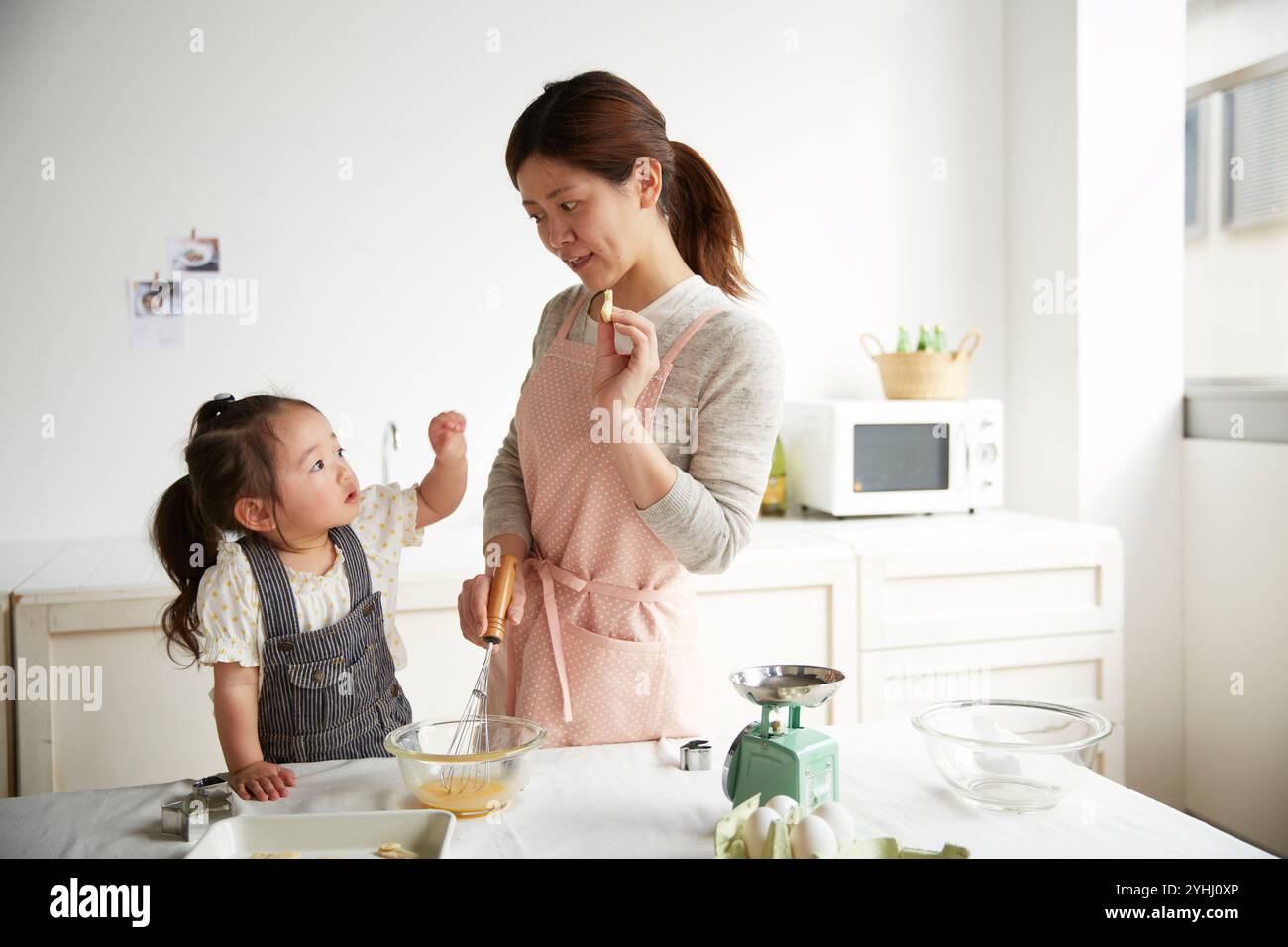 Girl cooking with her sister Stock Photo - Alamy