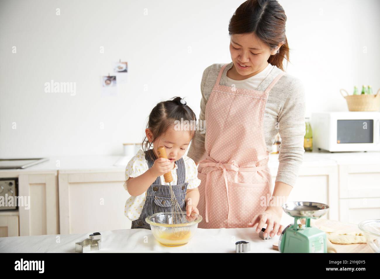 Girl cooking with her sister Stock Photo - Alamy
