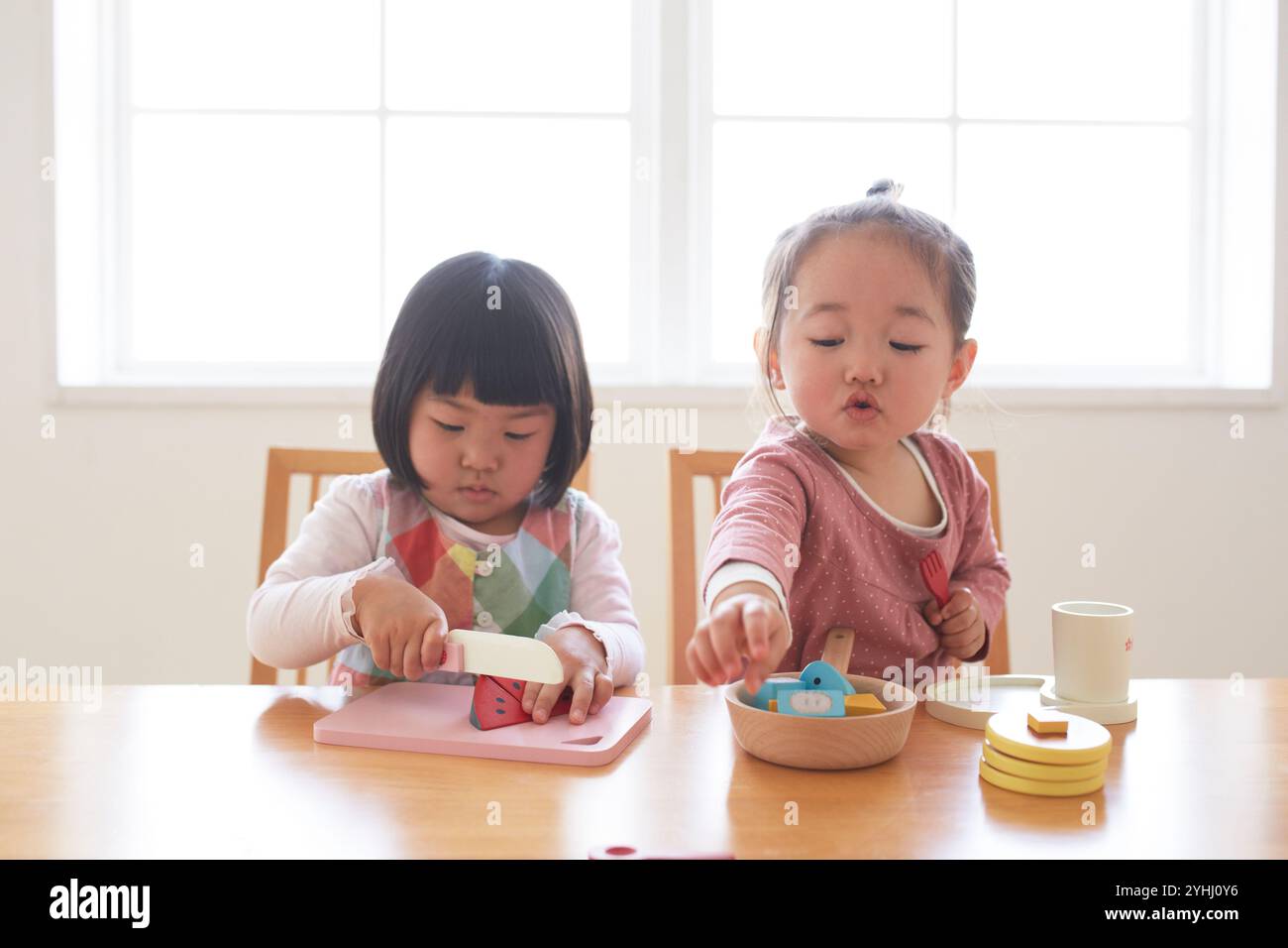 Two girls playing make-believe Stock Photo - Alamy
