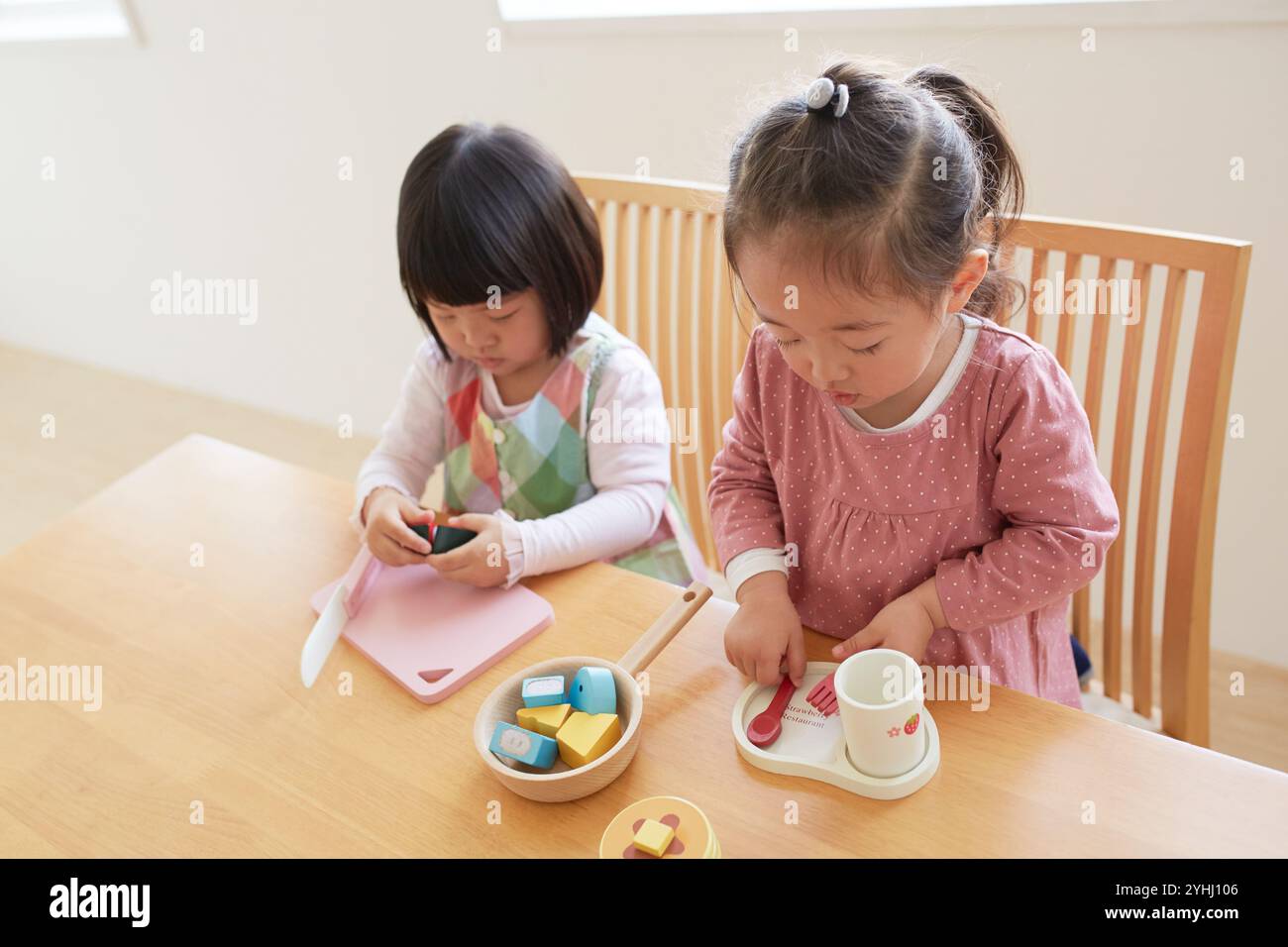 Two girls playing make-believe Stock Photo - Alamy