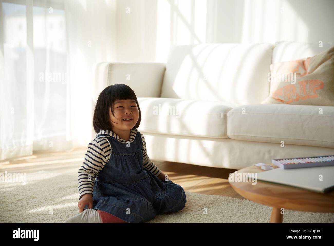 Sitting on floor carpet hi-res stock photography and images - Alamy