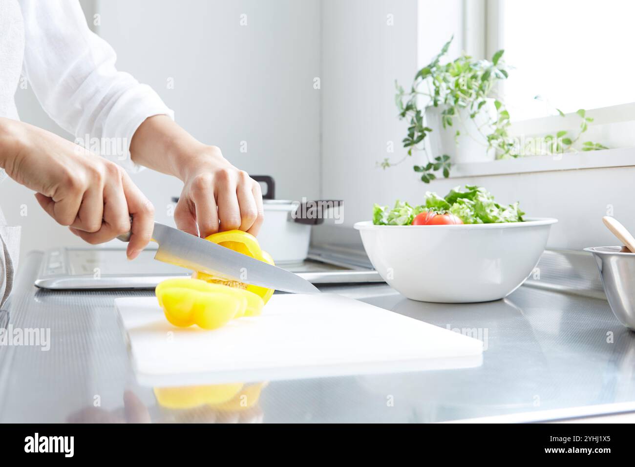 Woman's hand cutting vegetables in kitchen Stock Photo - Alamy