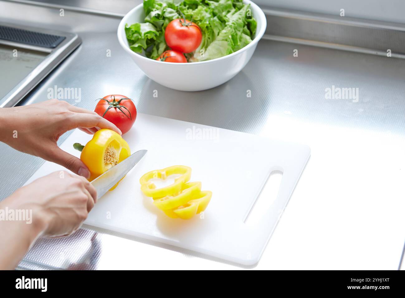 Woman's hand cutting vegetables in kitchen Stock Photo - Alamy