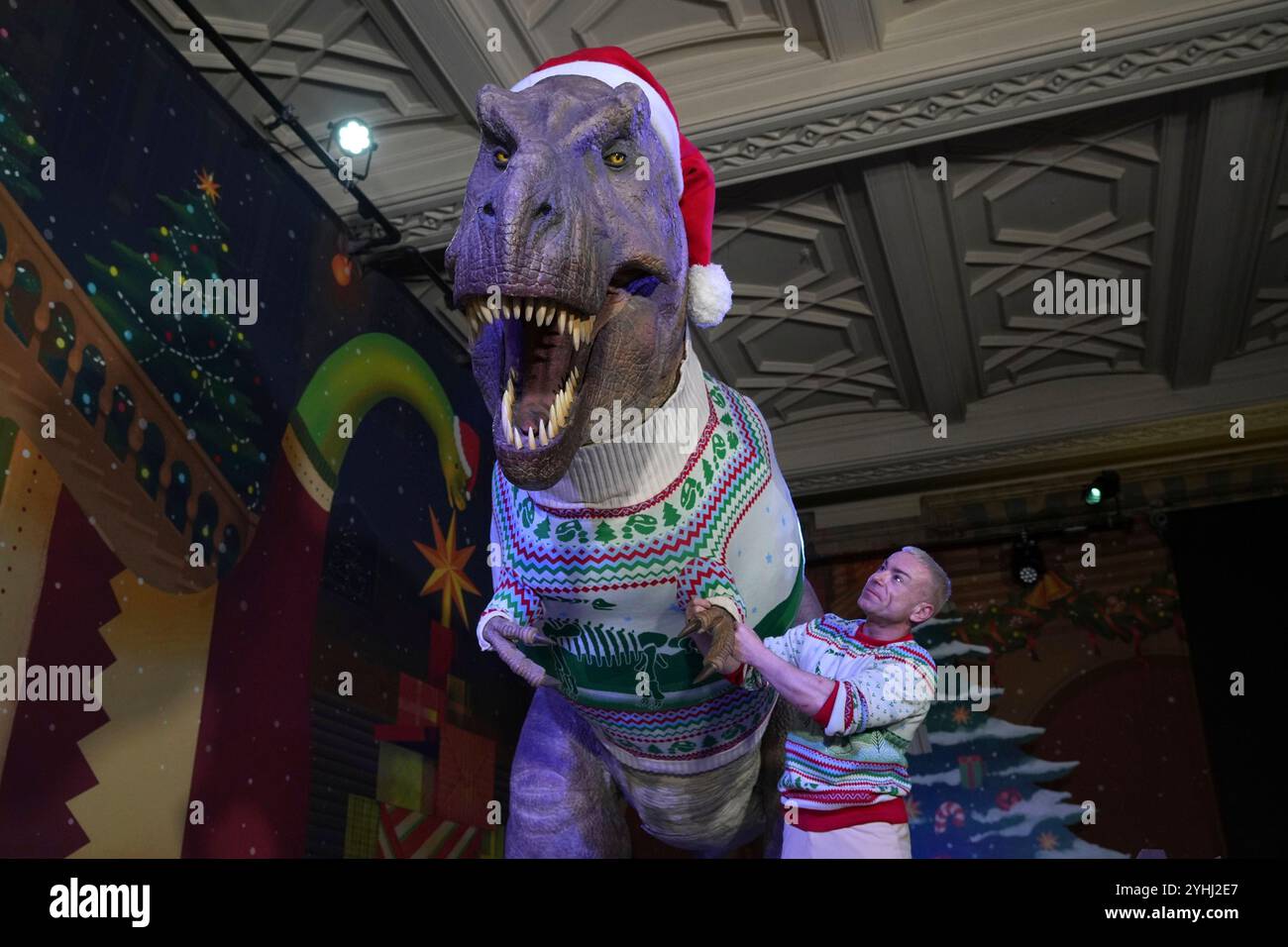A member of staff Sam Barnes poses with a T-Rex model, at the unveiling ...