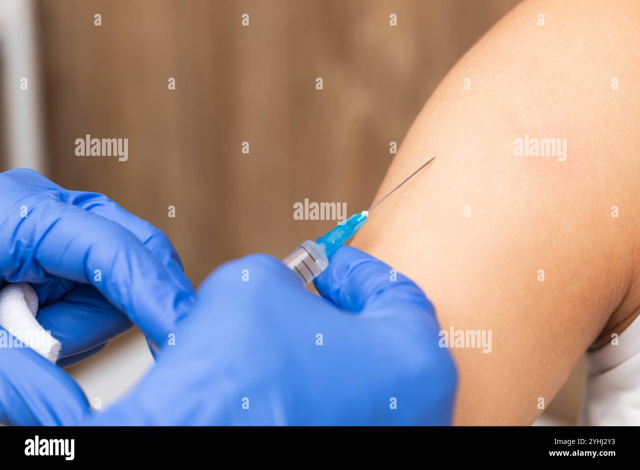 Close-up shot of medical assistant giving an intramuscular injection of ...