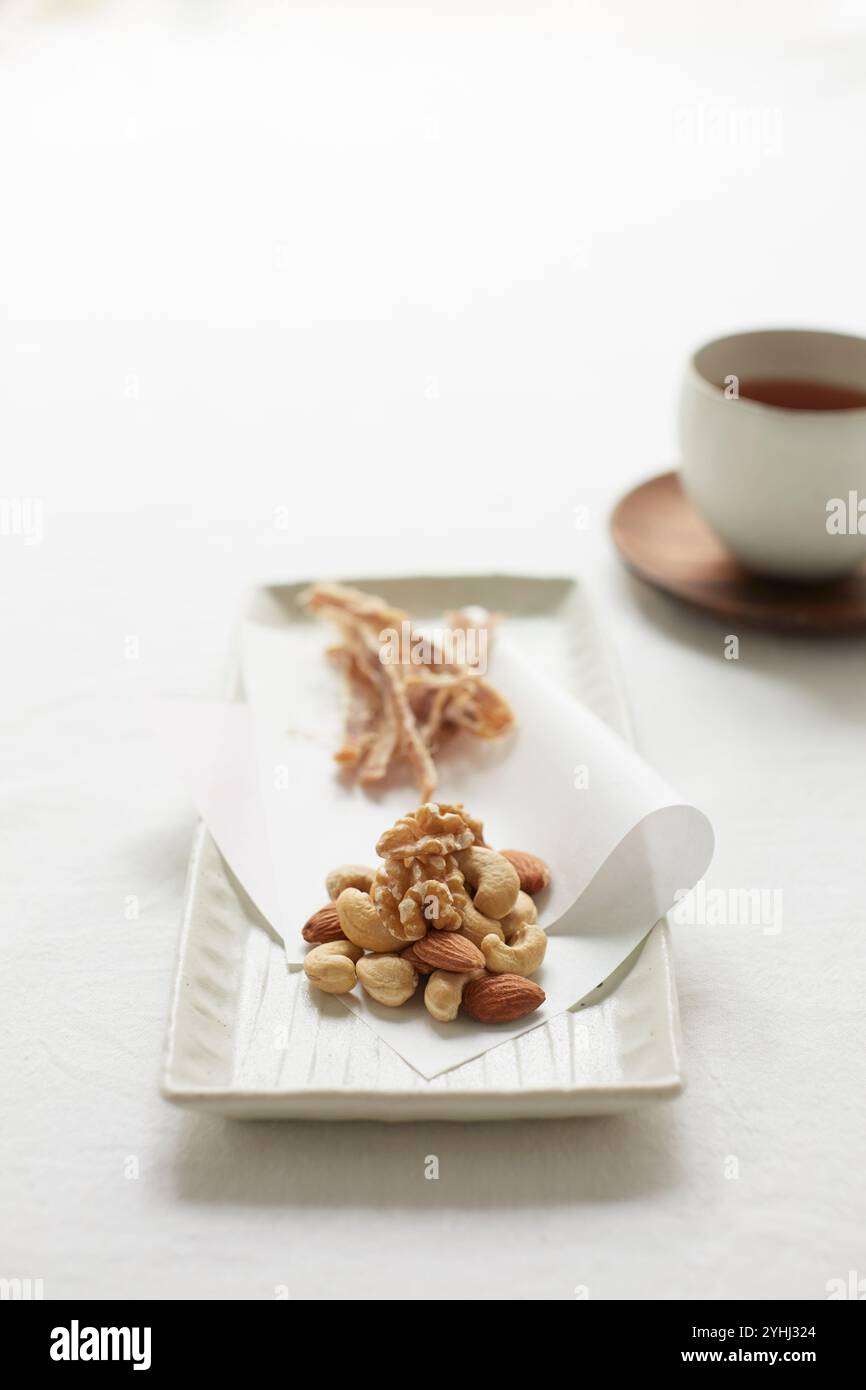 White plate, bowl and snacks on white background Stock Photo - Alamy