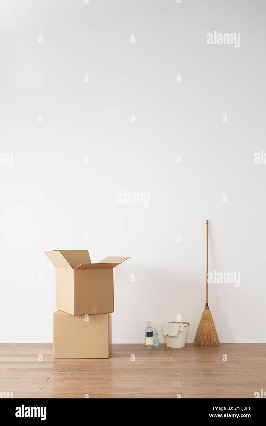 Stack of cardboard boxes and cleaning tools Stock Photo - Alamy