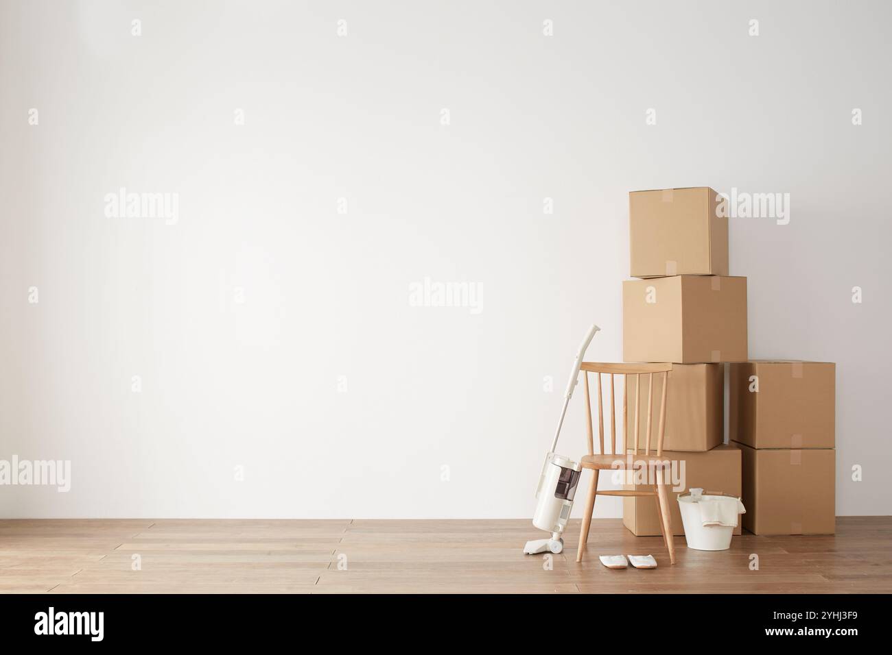 Pile of cardboard boxes, chairs and cleaning tools Stock Photo - Alamy