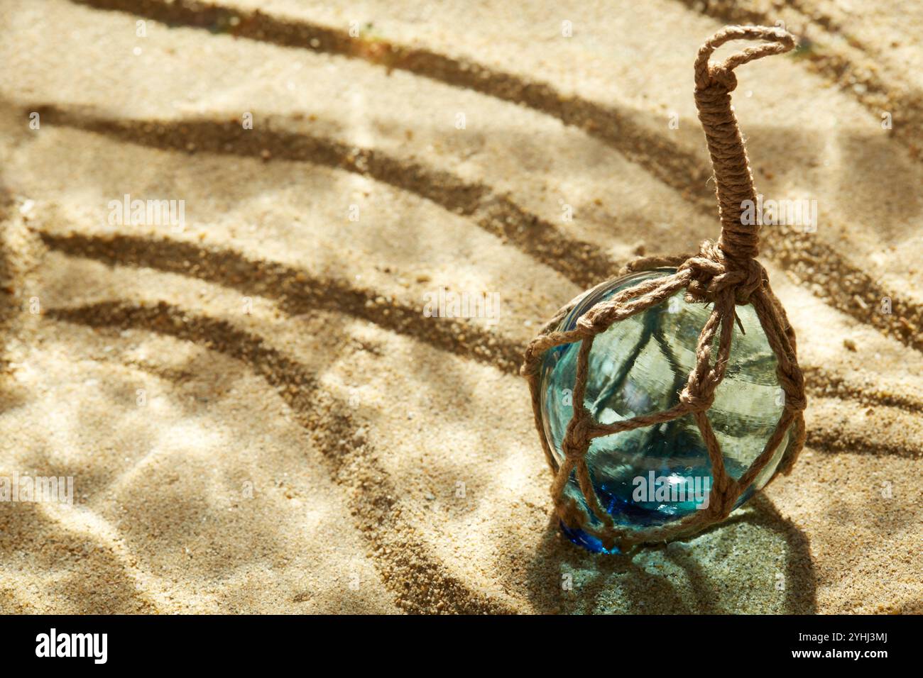 Underwater image with ripples reflected on sea sand and floating balls ...