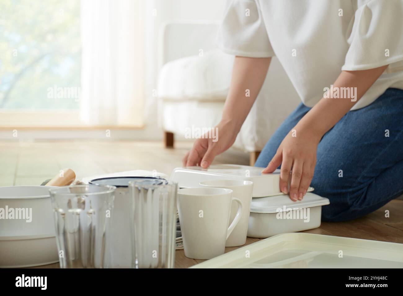 Woman removing items from cardboard boxes for moving Stock Photo - Alamy