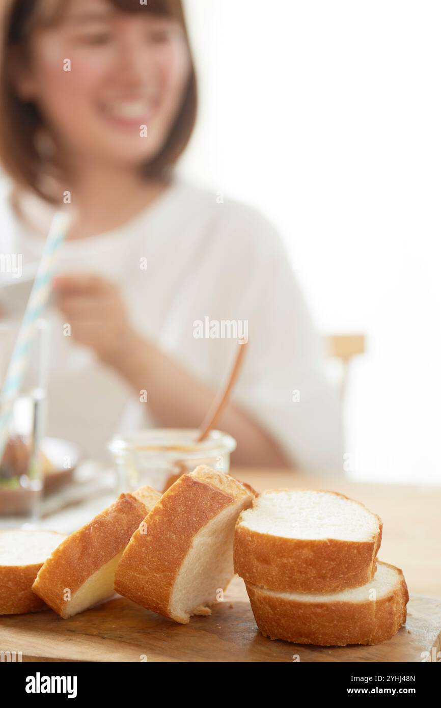 Bread and women on dining table Stock Photo - Alamy