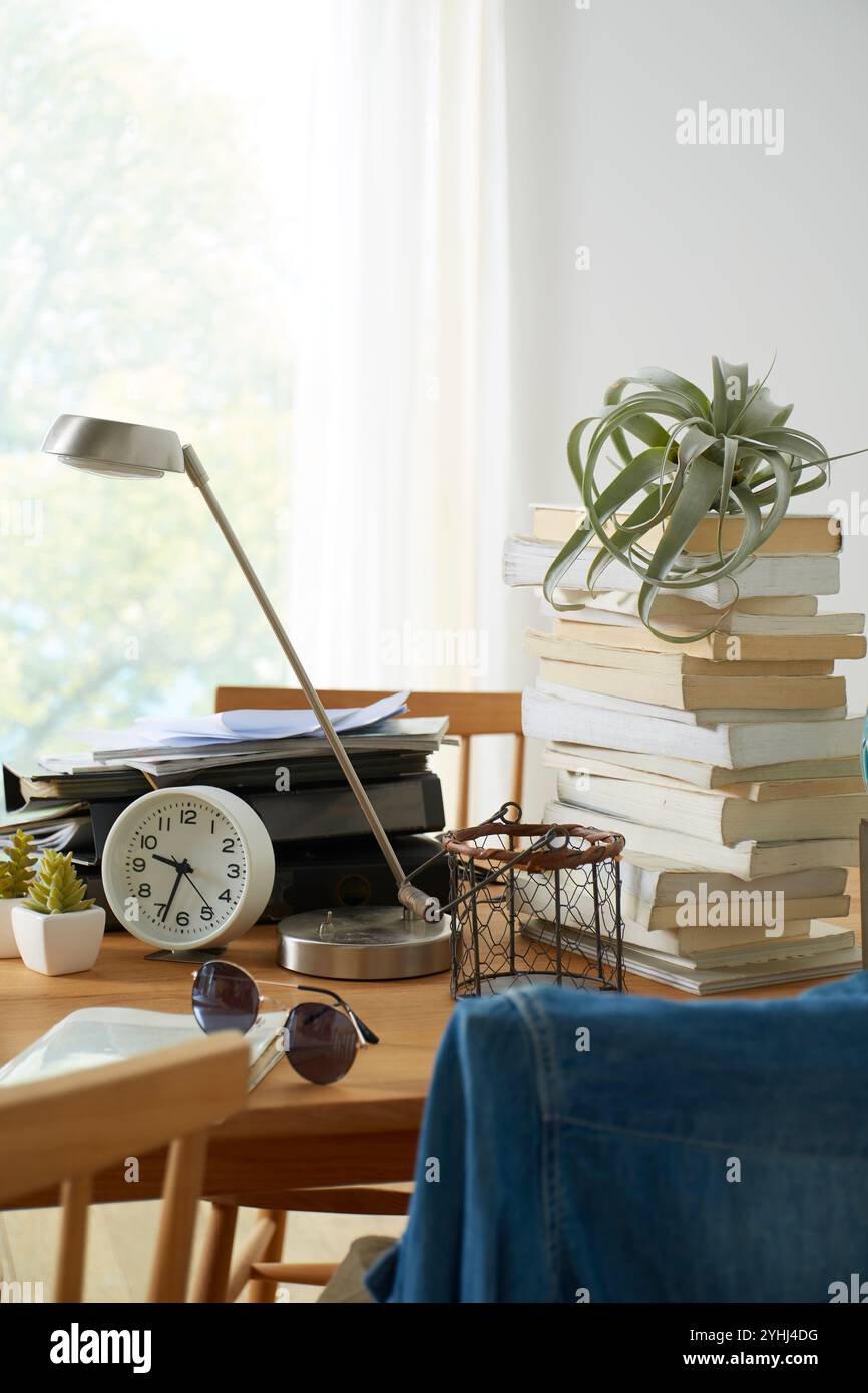 Books and shirts on the dining table Stock Photo - Alamy