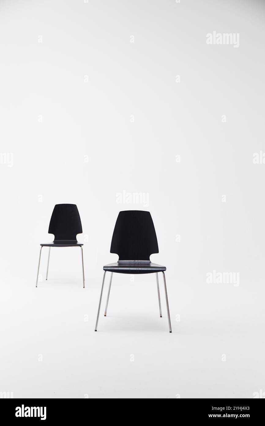 Two black chairs on white background Stock Photo - Alamy
