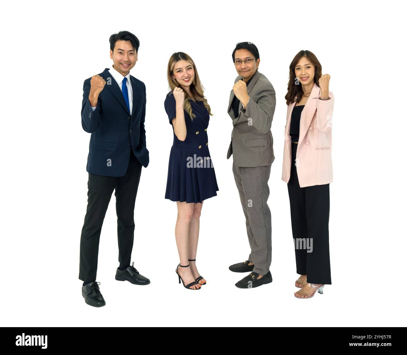 Four business professional stand together, raising their fist in ...