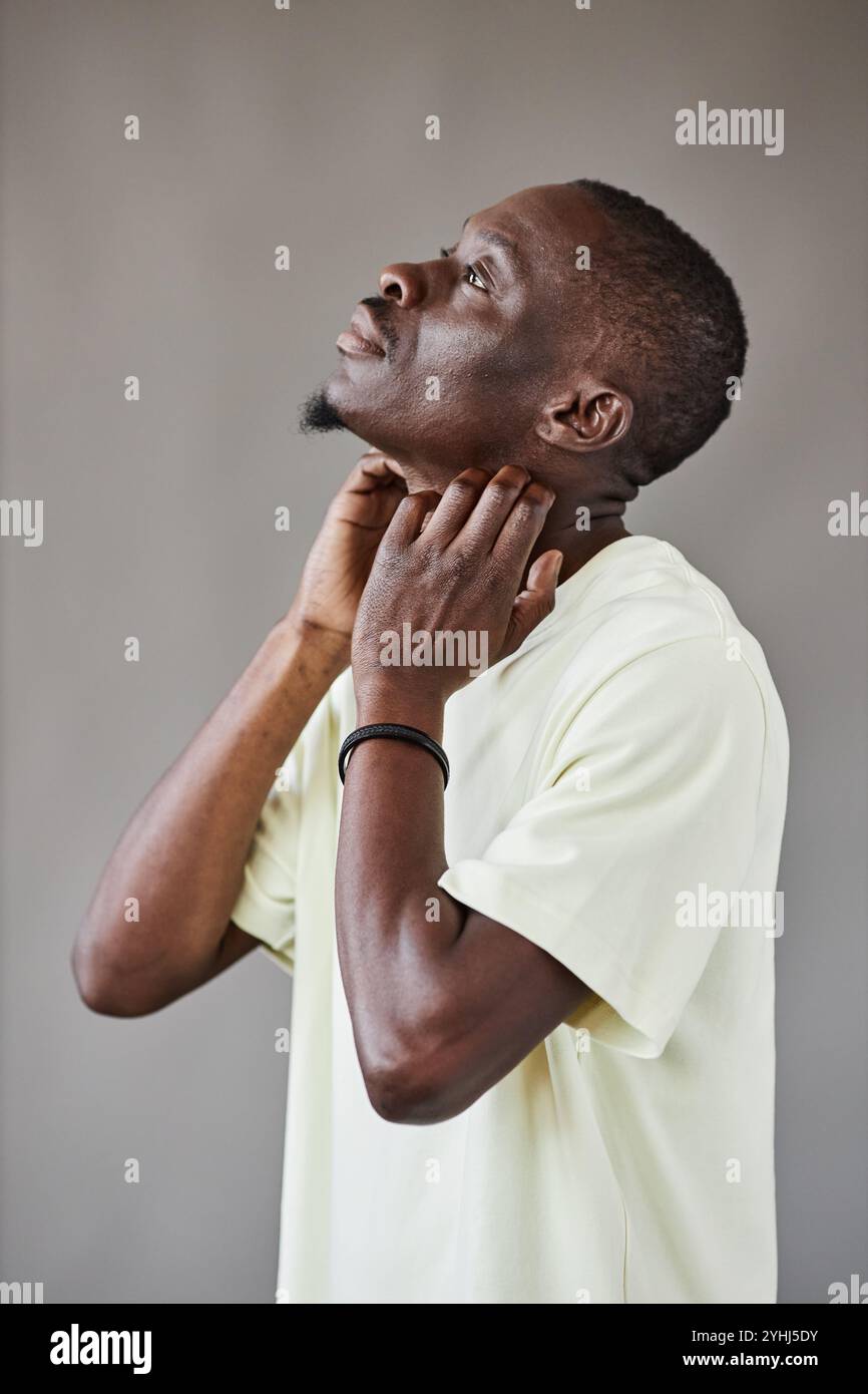 Minimal side view portrait of adult African American man suffering from ...
