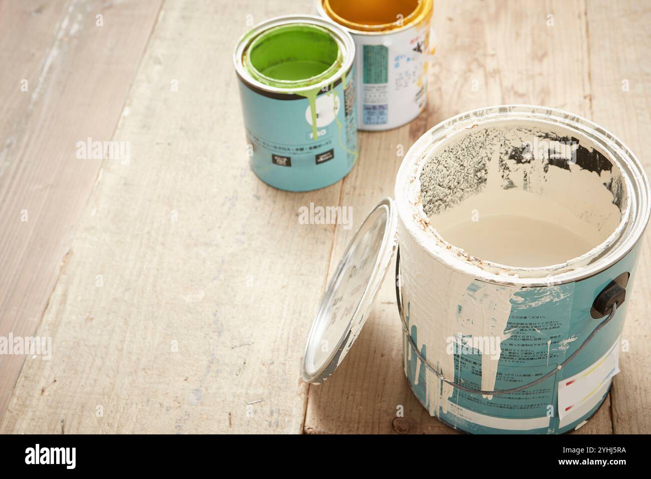 Three paint cans on the floor Stock Photo - Alamy