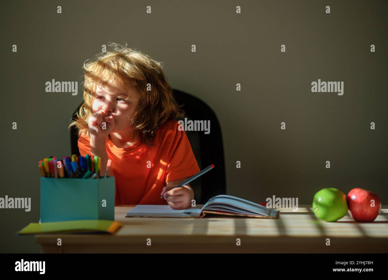 Little school kid boy doing homework at home. Child thinking, kids ...
