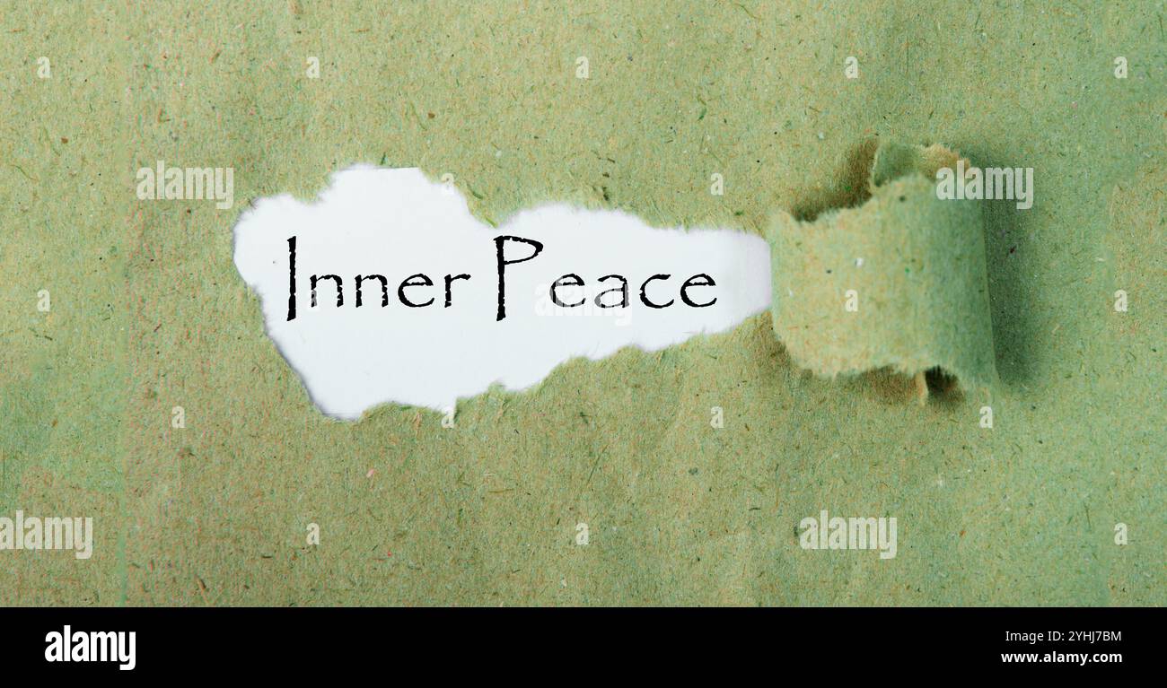 Inner peace message written on ripped torn paper piece with green ...