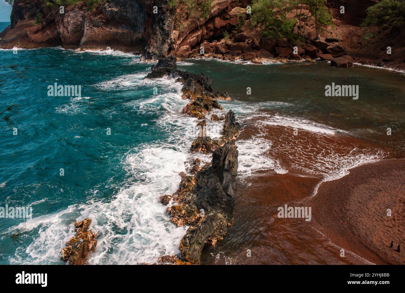 Beautiful ocean beach with large rocks on the shore and in the water ...