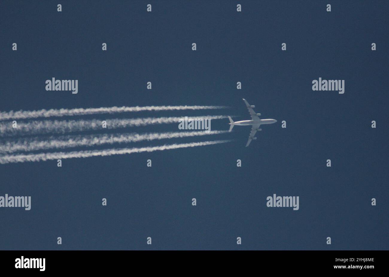 High Altitude Aircraft with Con Trails Stock Photo - Alamy