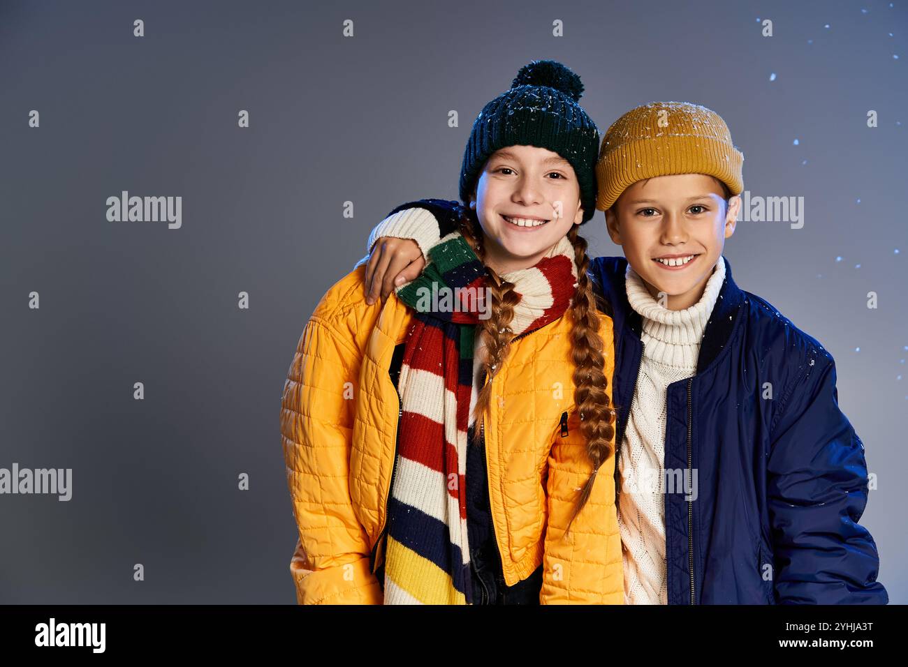 Happy kids in vibrant winter outfits share a joyful moment in a playful ...