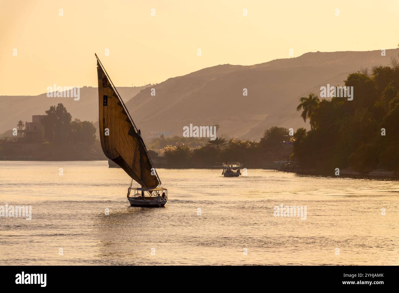 Felucca (traditinal egyptian sailing boat) on the Nile river at sunset ...