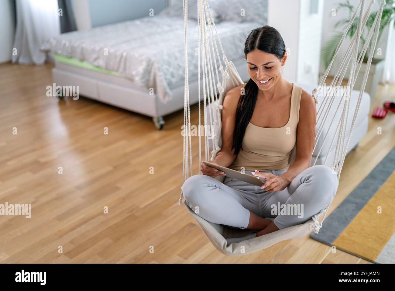 Happy beautiful woman watching videos or enjoying entertainment content ...