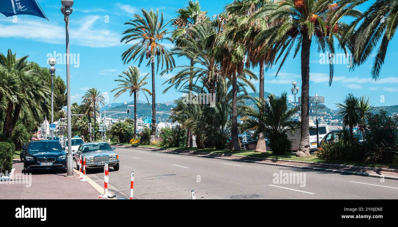 Nice, France - July 24, 2010: A scenic coastal road lined with palm ...