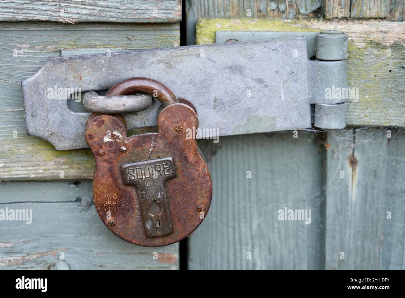 Old rusty Squire Old English padlock on a rustic shed door Stock Photo ...