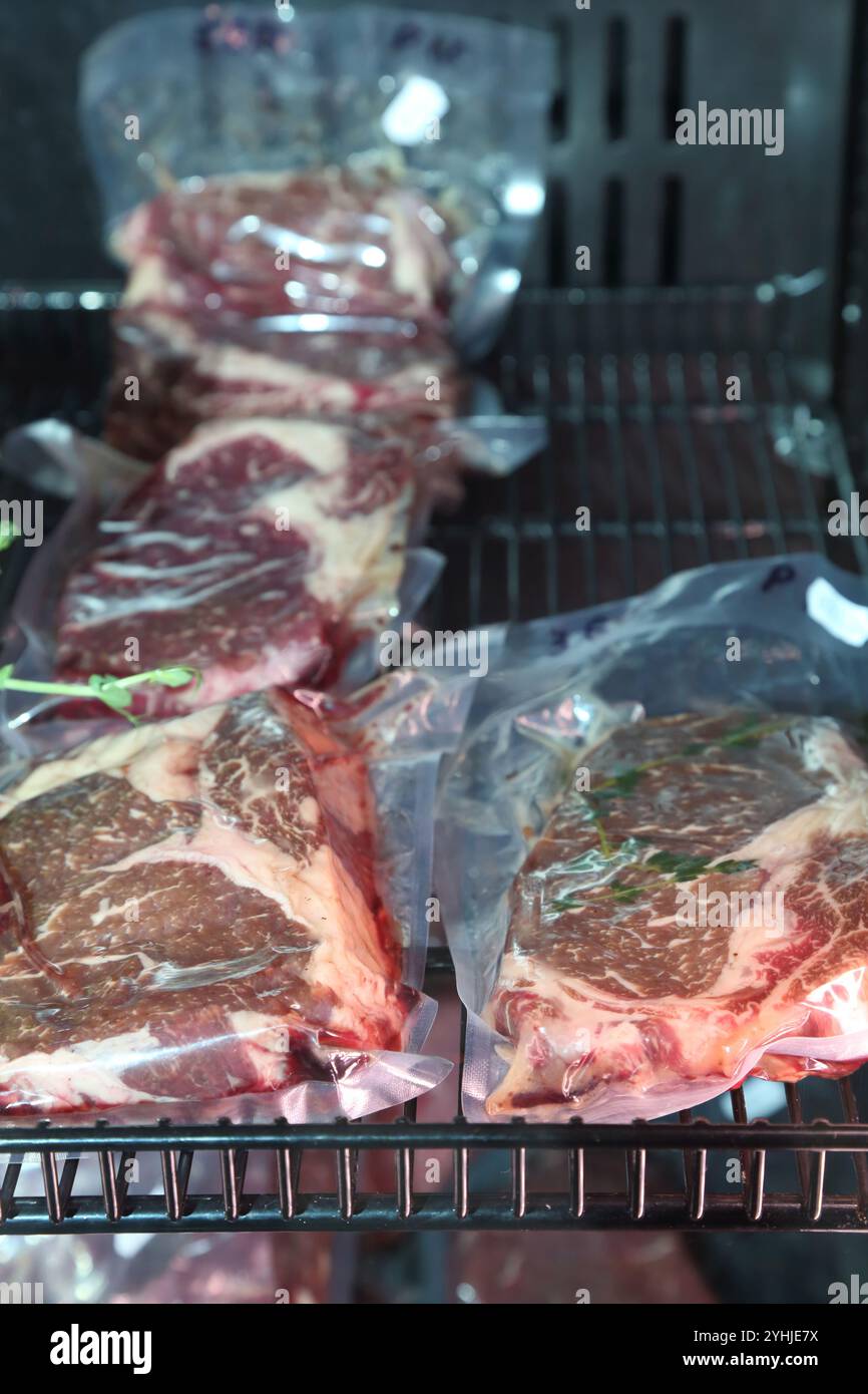 Beef steaks are kept in a special refrigerator before being cooked ...