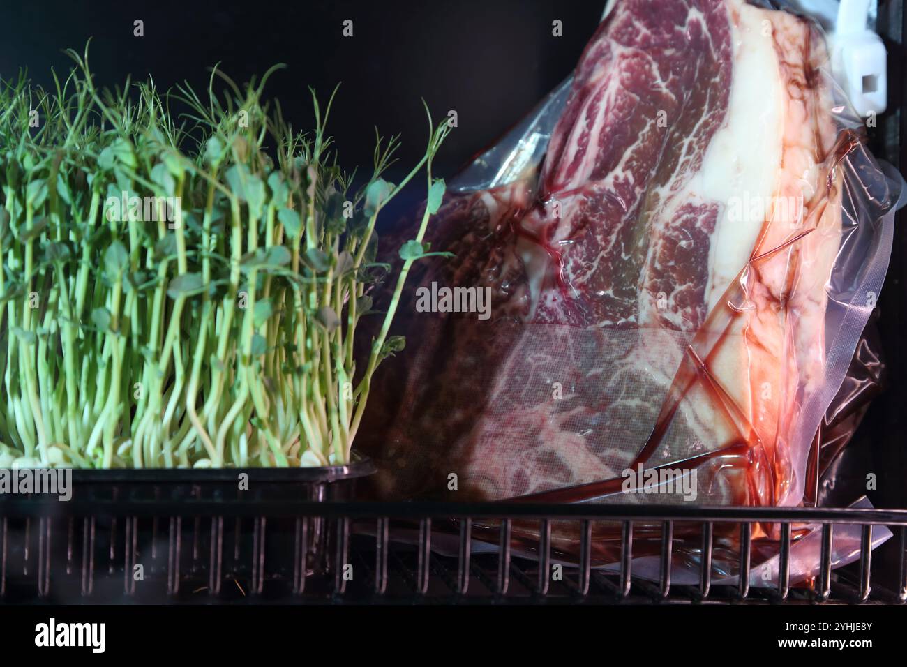 Beef steaks are kept in a special refrigerator before being cooked ...