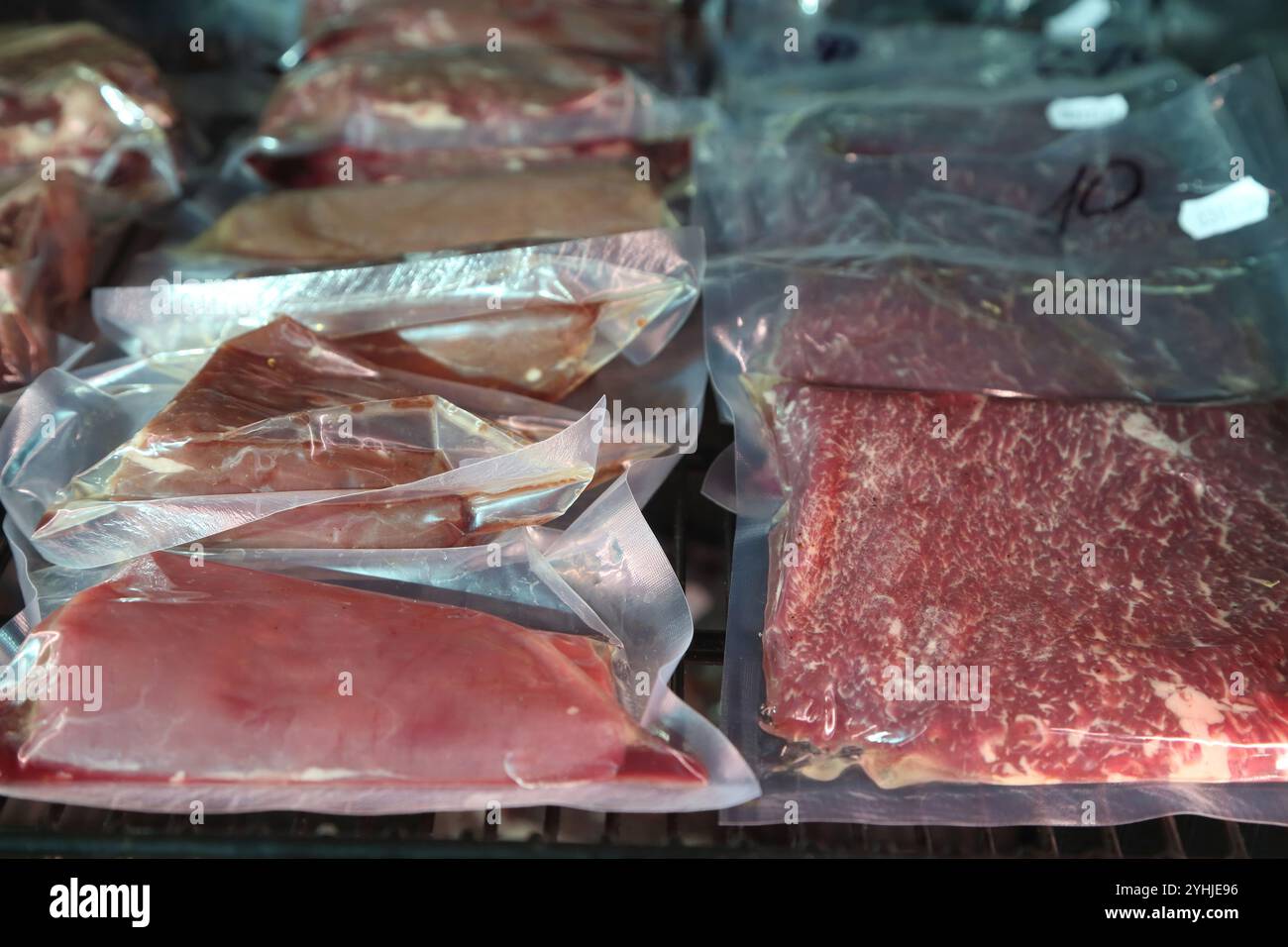 Beef steaks are kept in a special refrigerator before being cooked ...