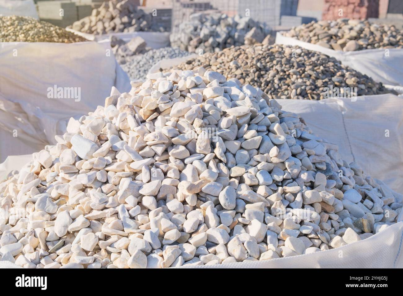 Decorative stones are sold in construction market. Beige pebbles ...