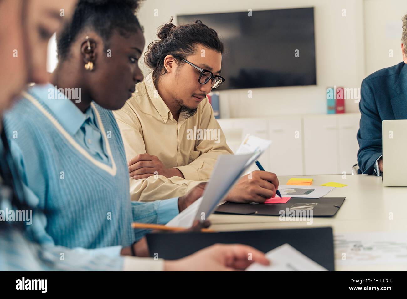 Office professionals reviewing documents showcasing hi-res stock ...