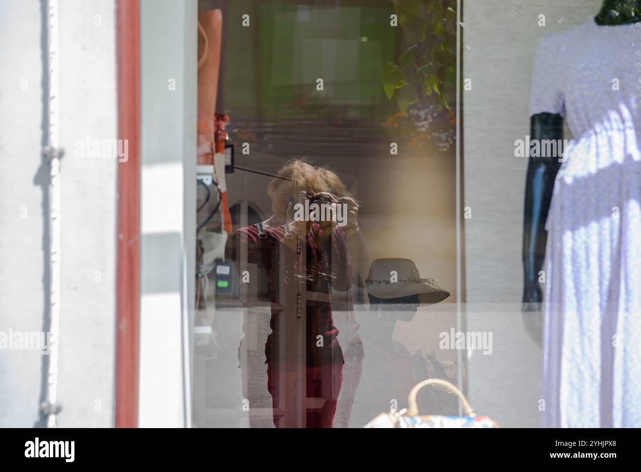 One person reflected in building window hi-res stock photography and ...