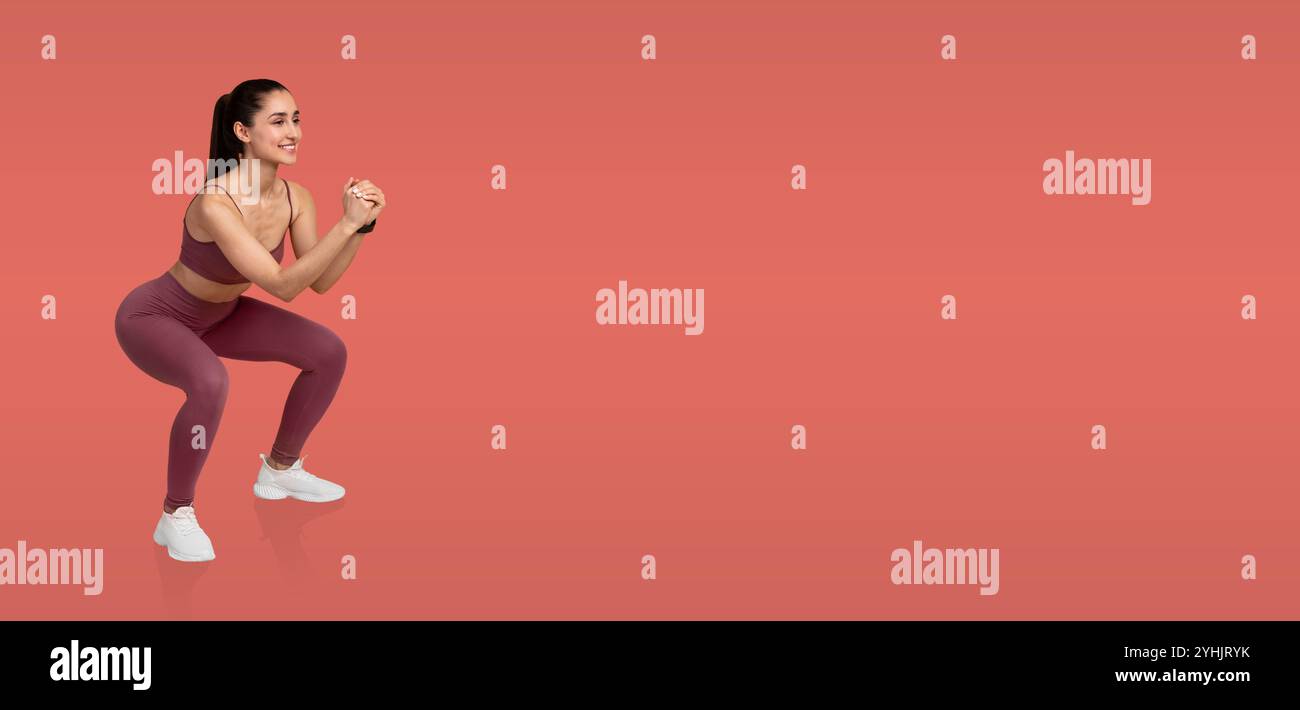 Woman performing squats on a colorful background for fitness training ...
