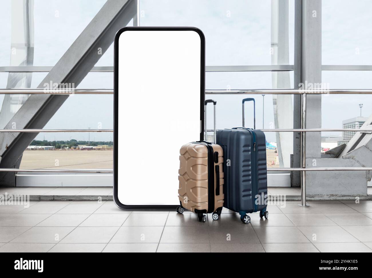 Luggage and blank advertising display in modern airport terminal during ...