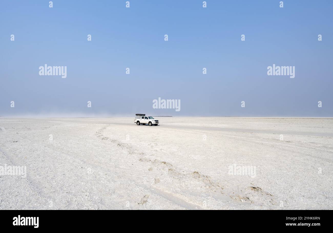 Four-wheel drive Toyota Hilux with roof tent, driving over salt pan ...