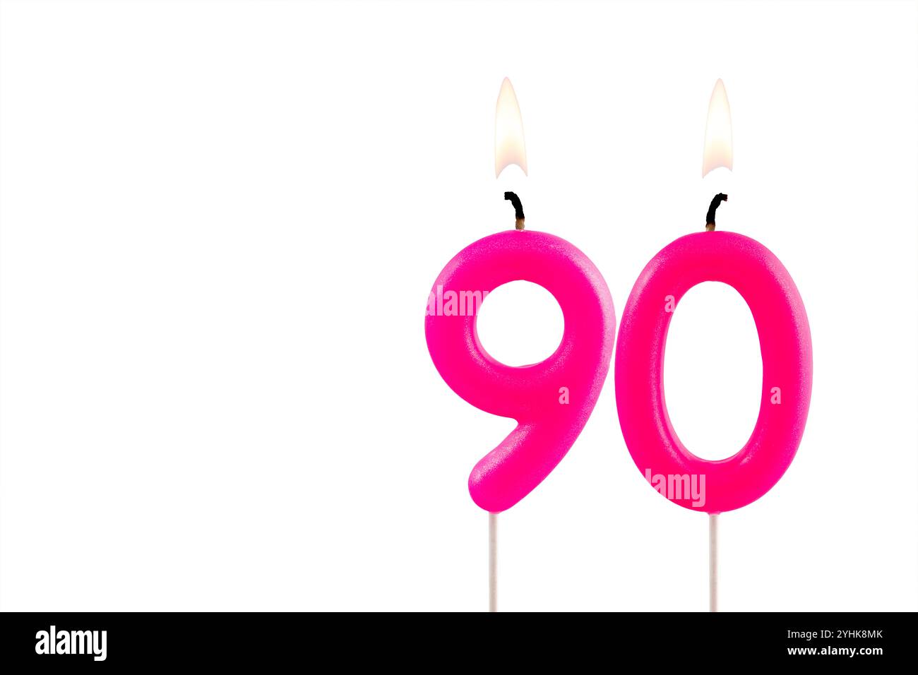 Pink number 90 birthday candle lit on white background Stock Photo - Alamy