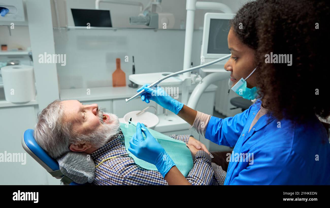 Dentist demonstrates correct brushing techniques, showing patient ...