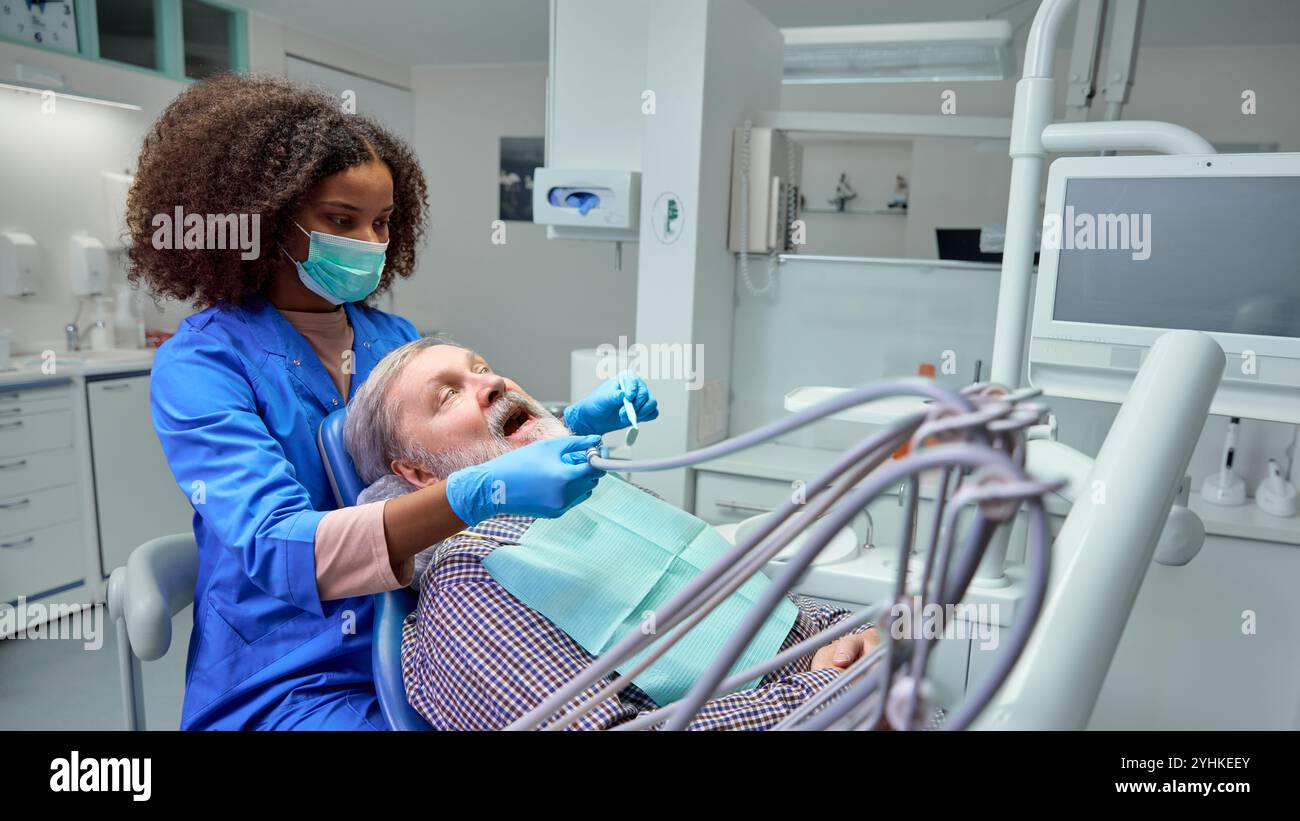 Dentist demonstrates correct brushing techniques, showing patient ...