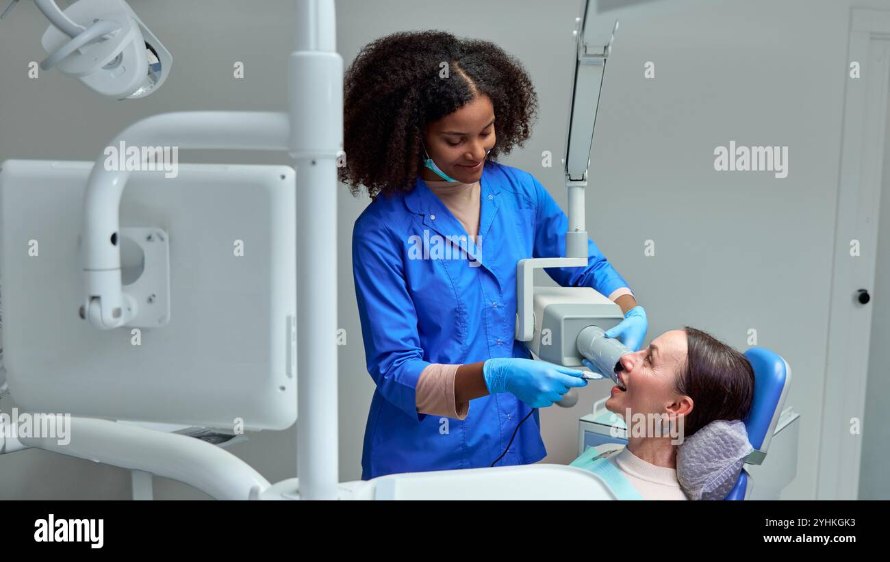 Dentist prepares to take detailed dental X-ray, guiding patient through ...