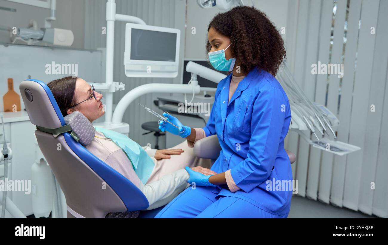 Dentist explains anesthesia effects, helping mature man, patient feel calm and ready for ...