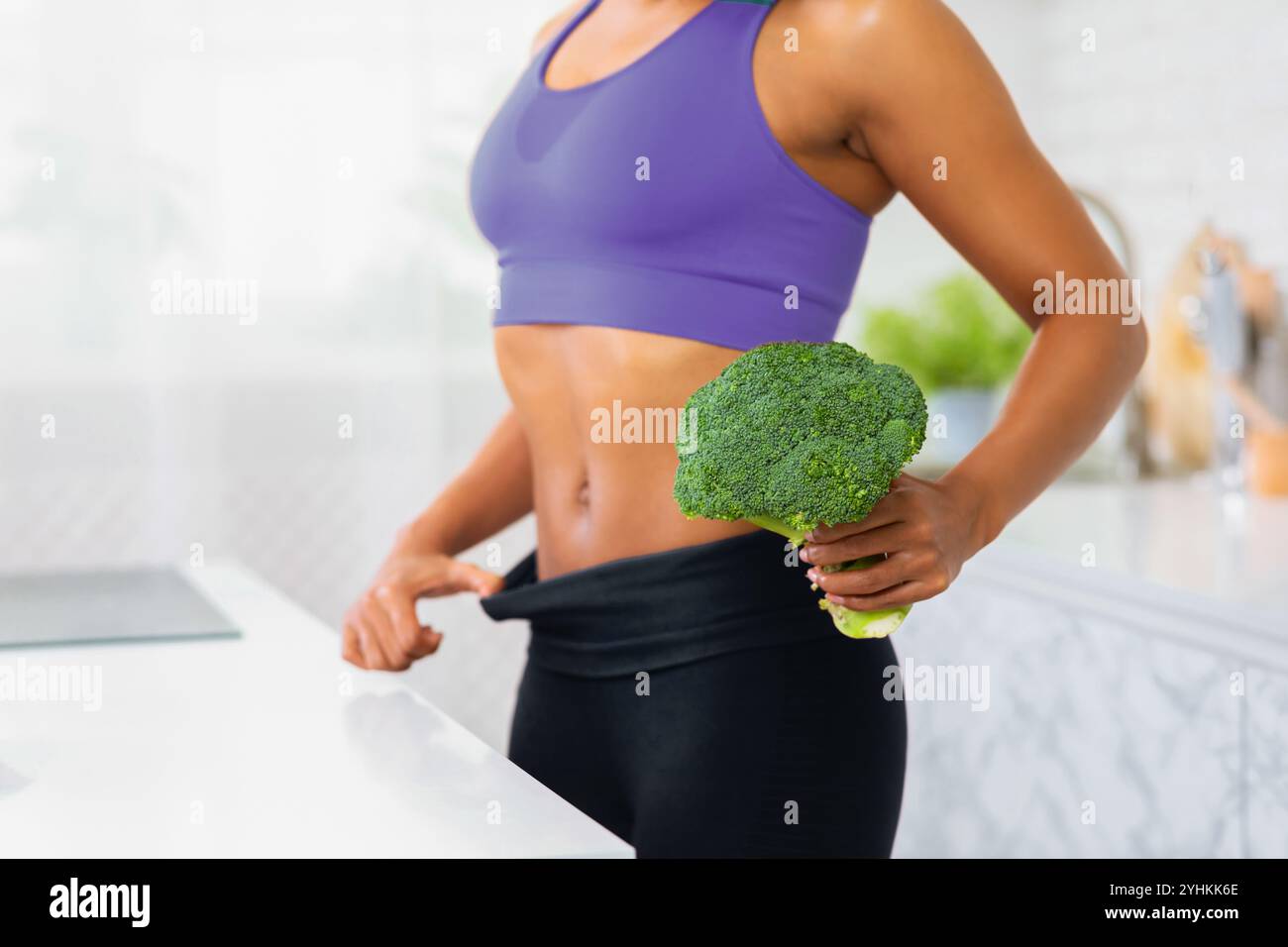 Fit Afro Girl In Oversize Pants Holding Broccoli Stock Photo - Alamy