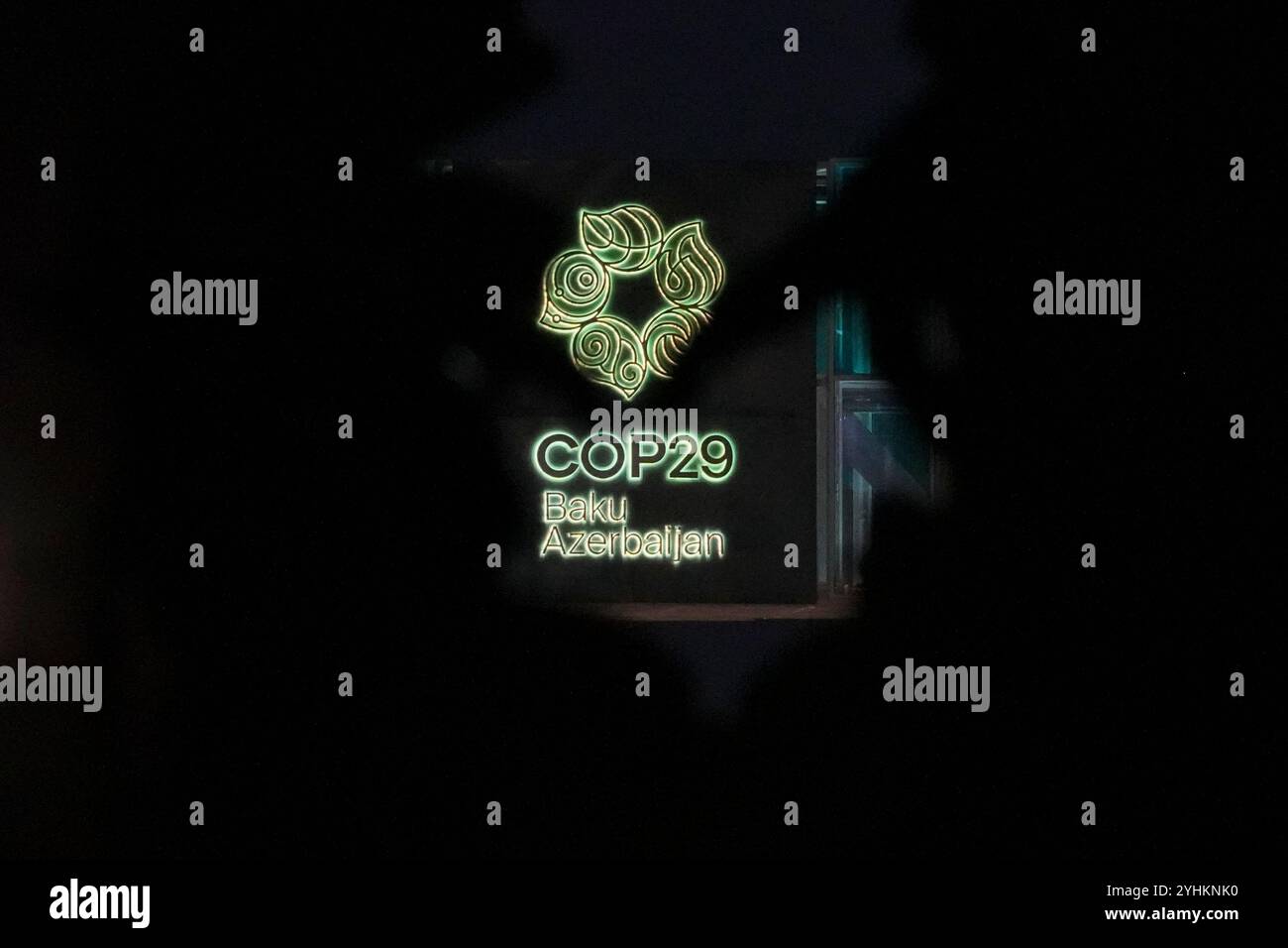 The logo for the COP29 U.N. Climate Summit is visible through artwork ...