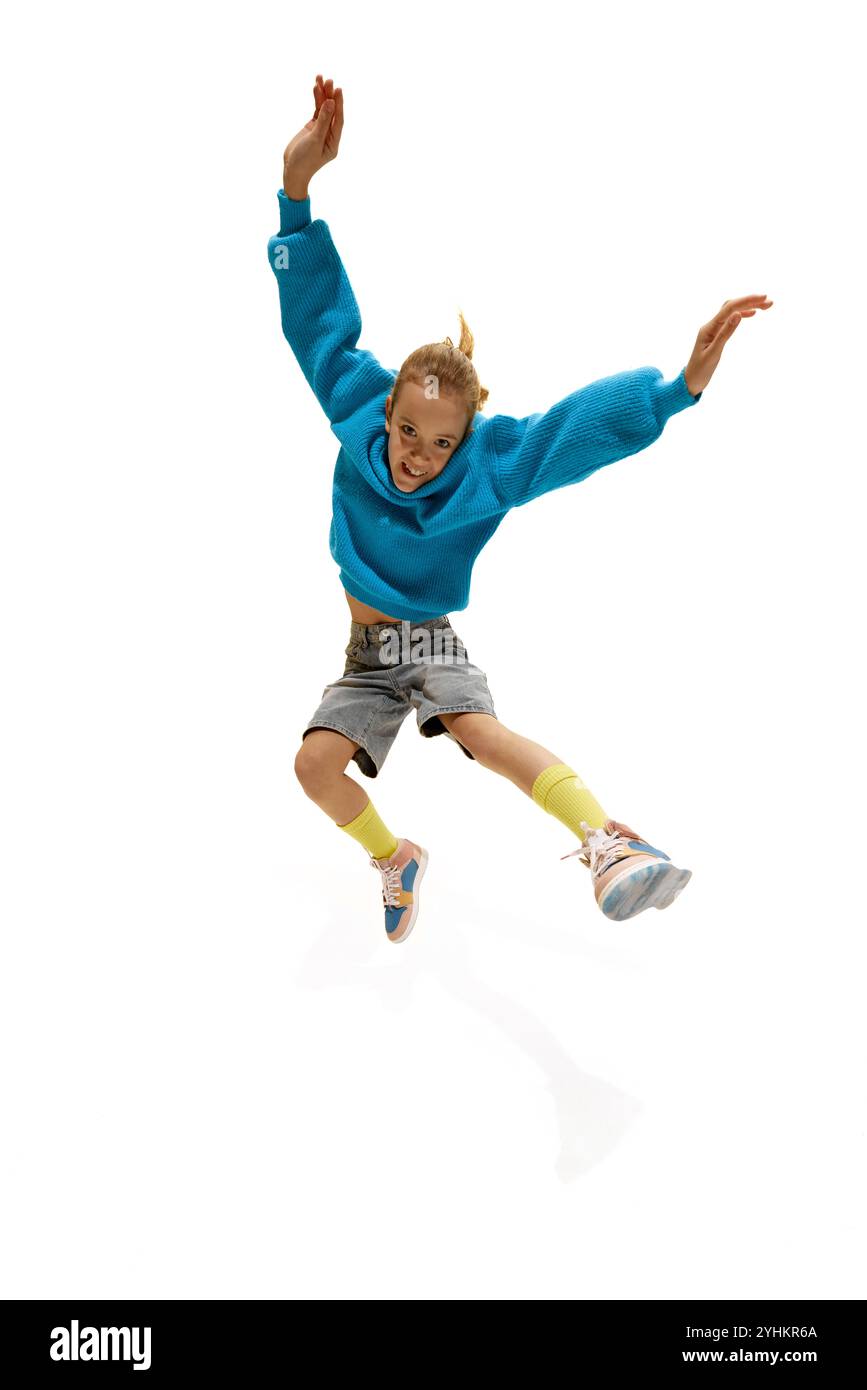 Happy, charming girl dressed colorful old-school clothes jumping with ...