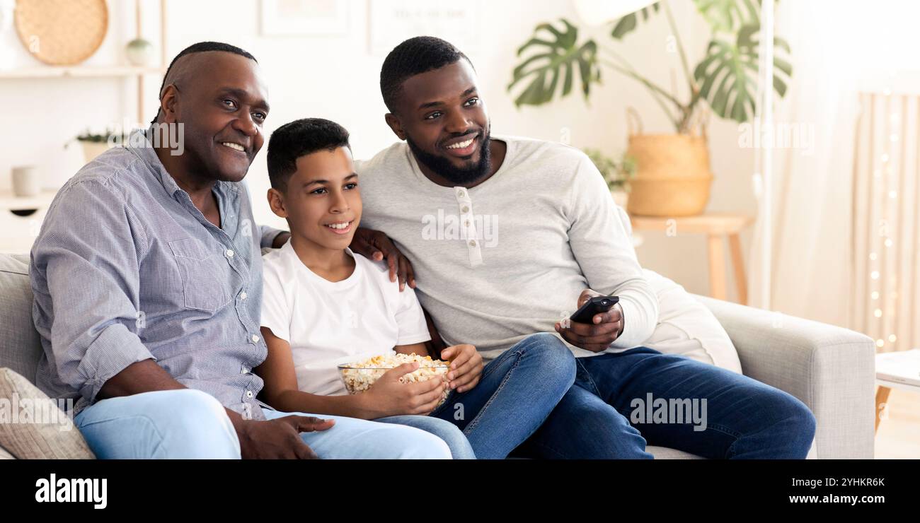 Cheerful african grandpa, father and son relaxing together in living ...