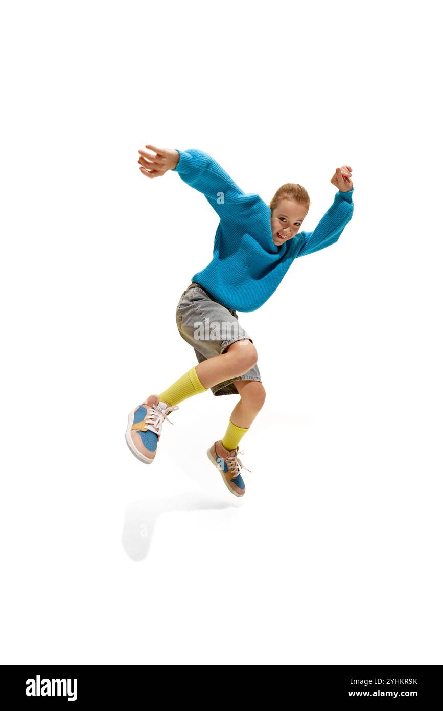 Happy, charming girl dressed colorful old-school clothes jumping with ...