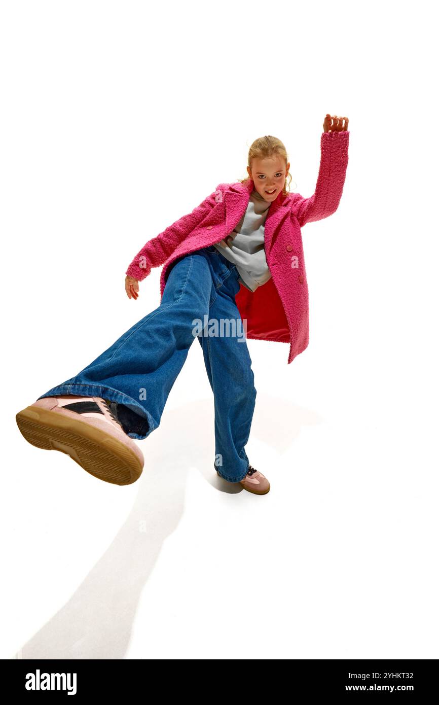 Low angle photo of little, teen girl dancing raising hands and waving ...